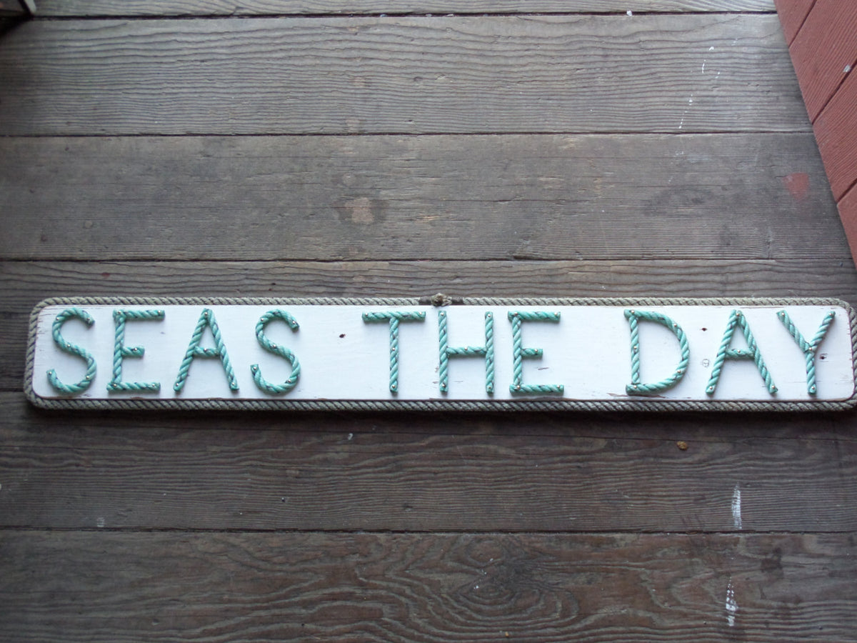 SEAS THE DAY sign – Alaska Rug Company